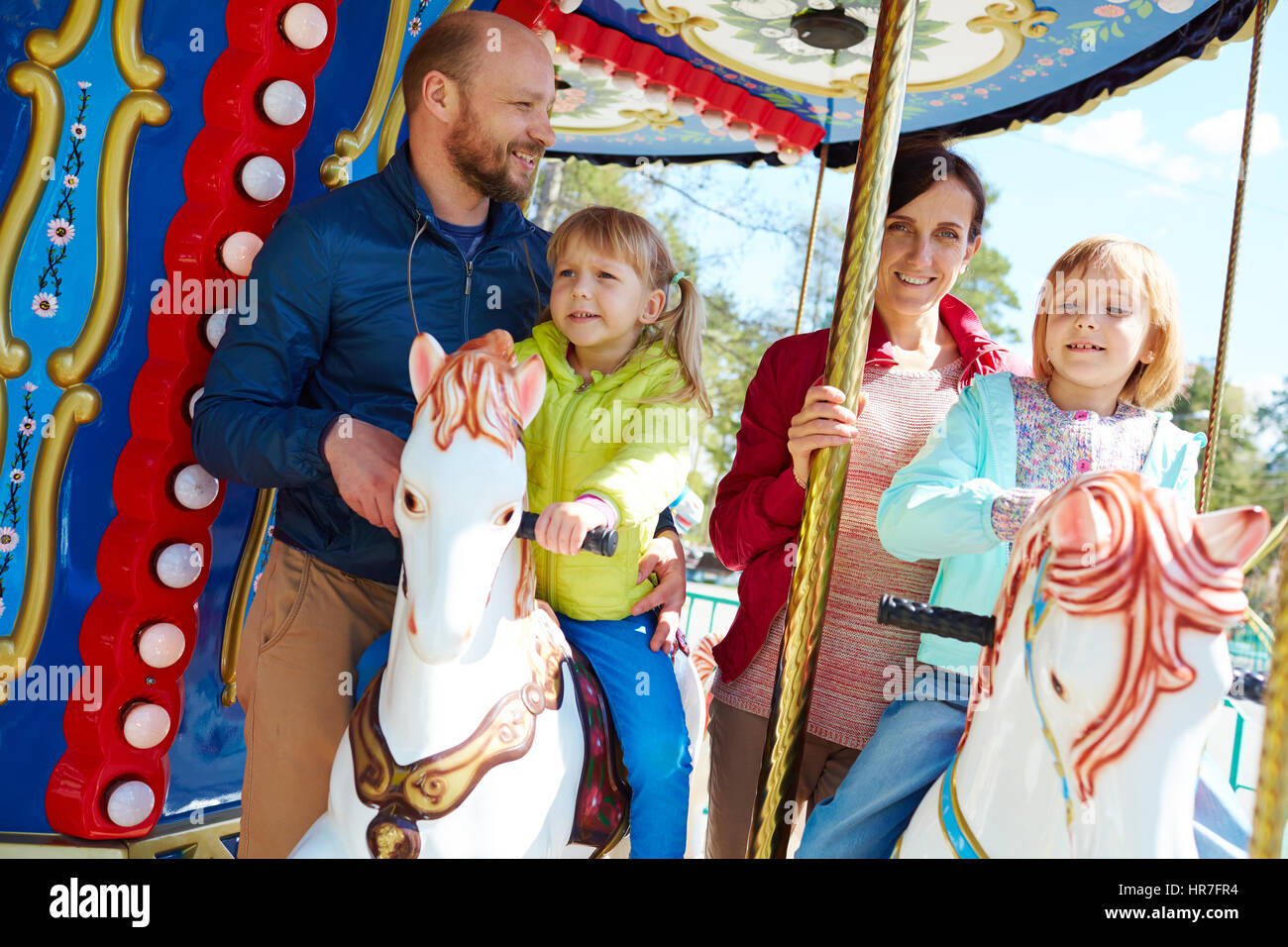 Portrait of pretty middle-aged couple in windbreakers standing on ...