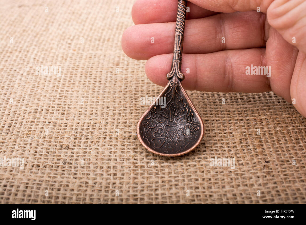 Teaspoon made of metal in the hand Stock Photo - Alamy