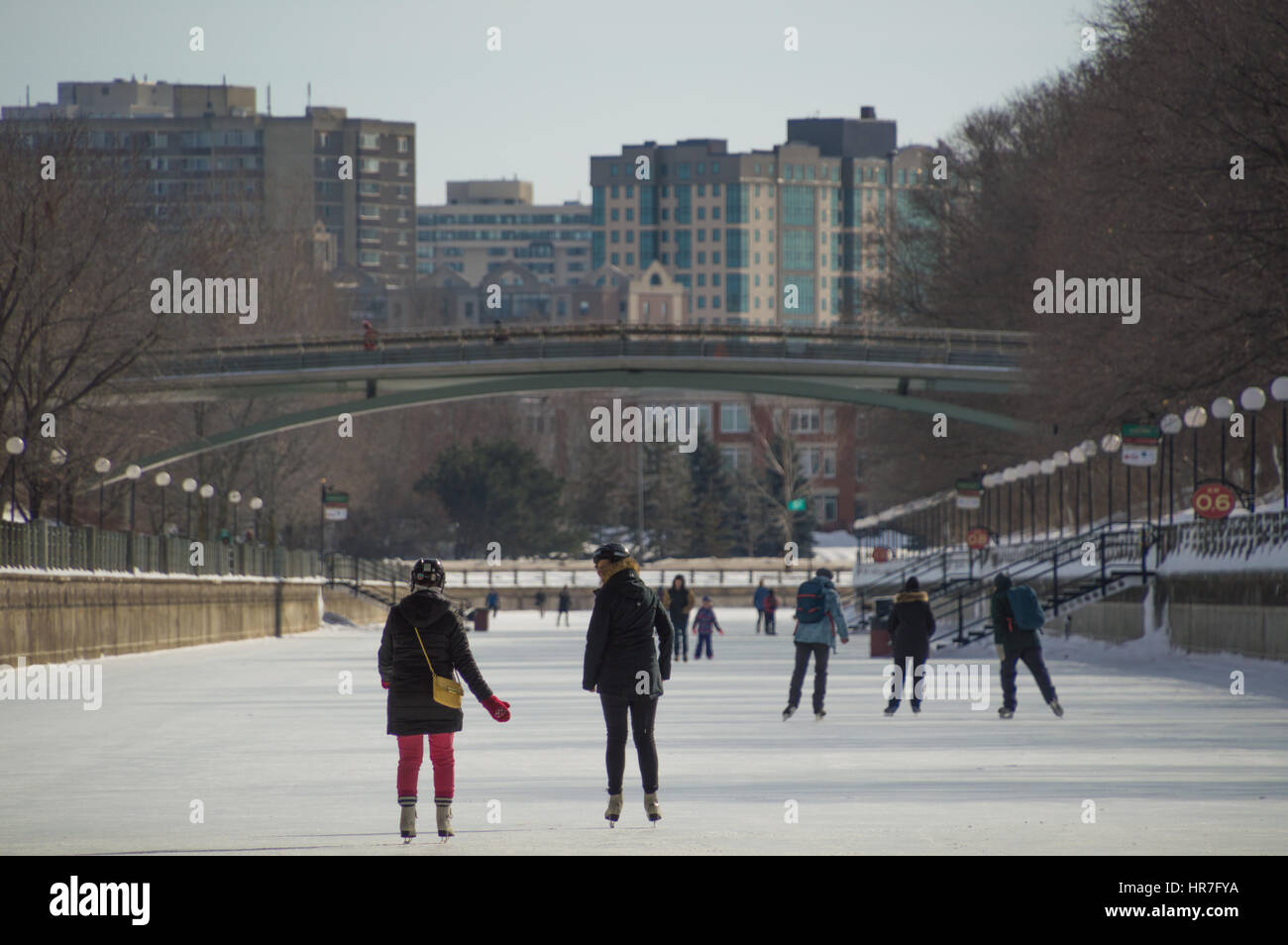 People ice skating on the frozen Rideau canal, Ottawa on a sunny day ...