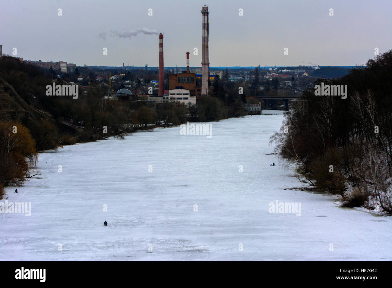 Fishermen on the river in winter ice fishing before the ice melting ...