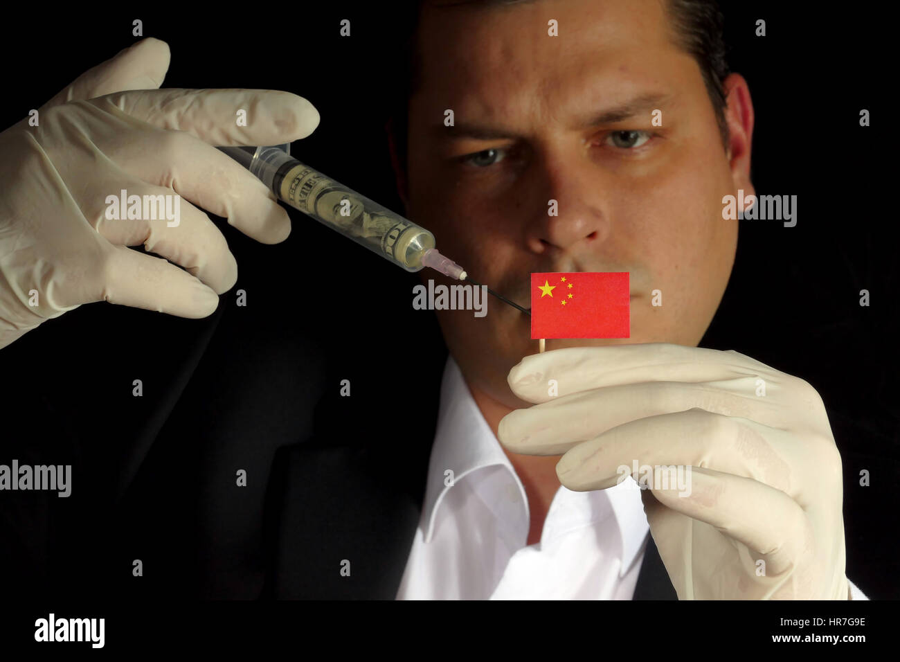 Young businessman gives a financial injection to Chinese flag isolated ...