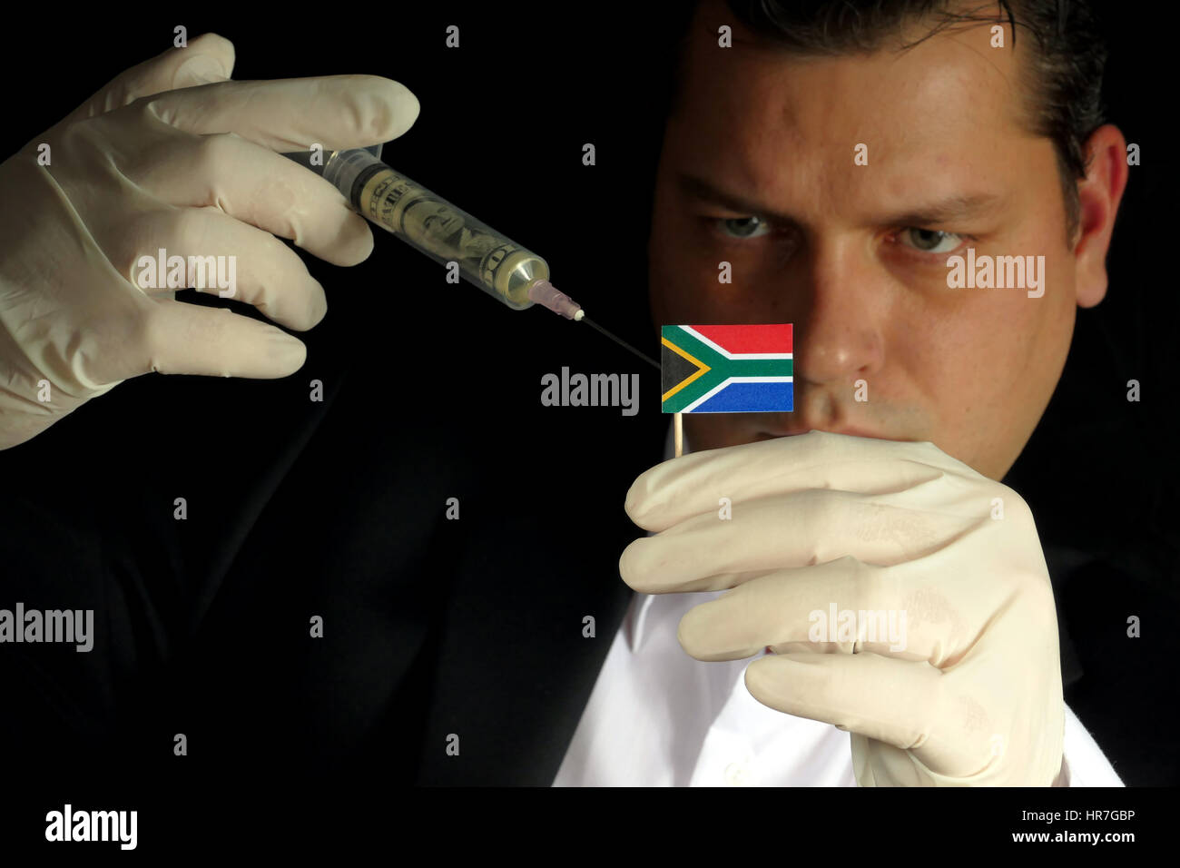 Young businessman gives a financial injection to South African flag ...