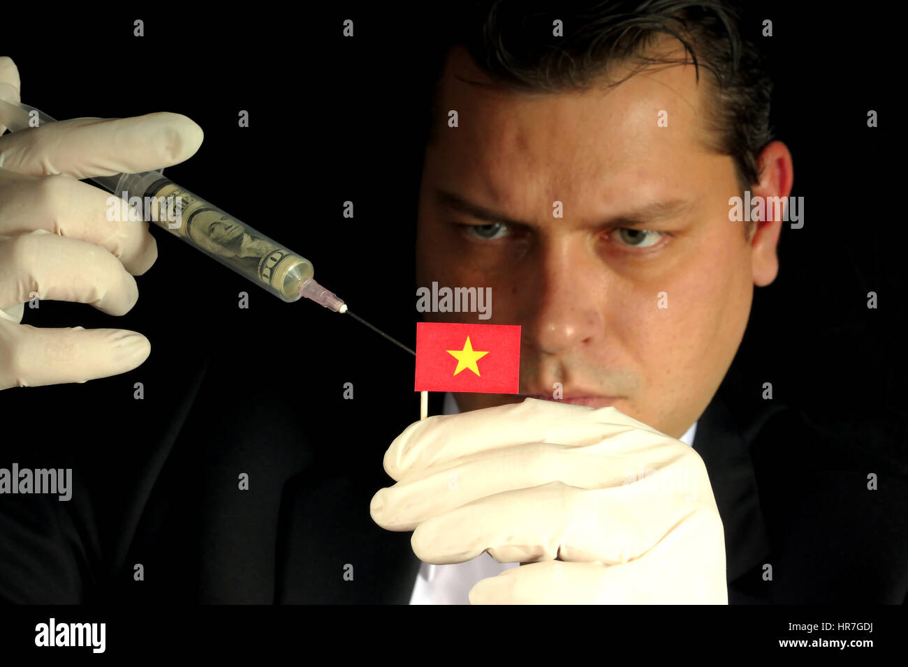 Young businessman gives a financial injection to Vietnamese flag ...