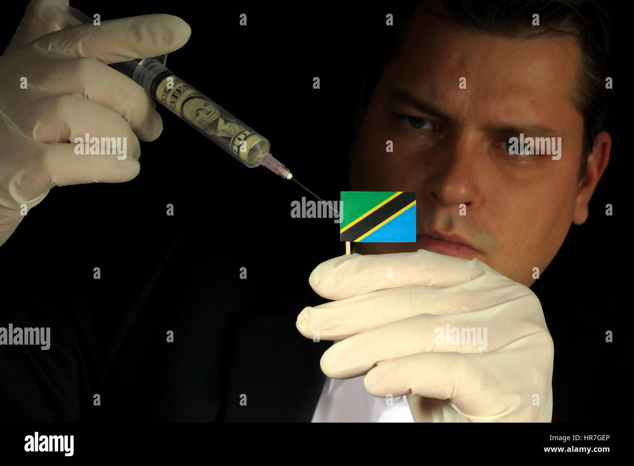 Young businessman gives a financial injection to Tanzanian flag ...