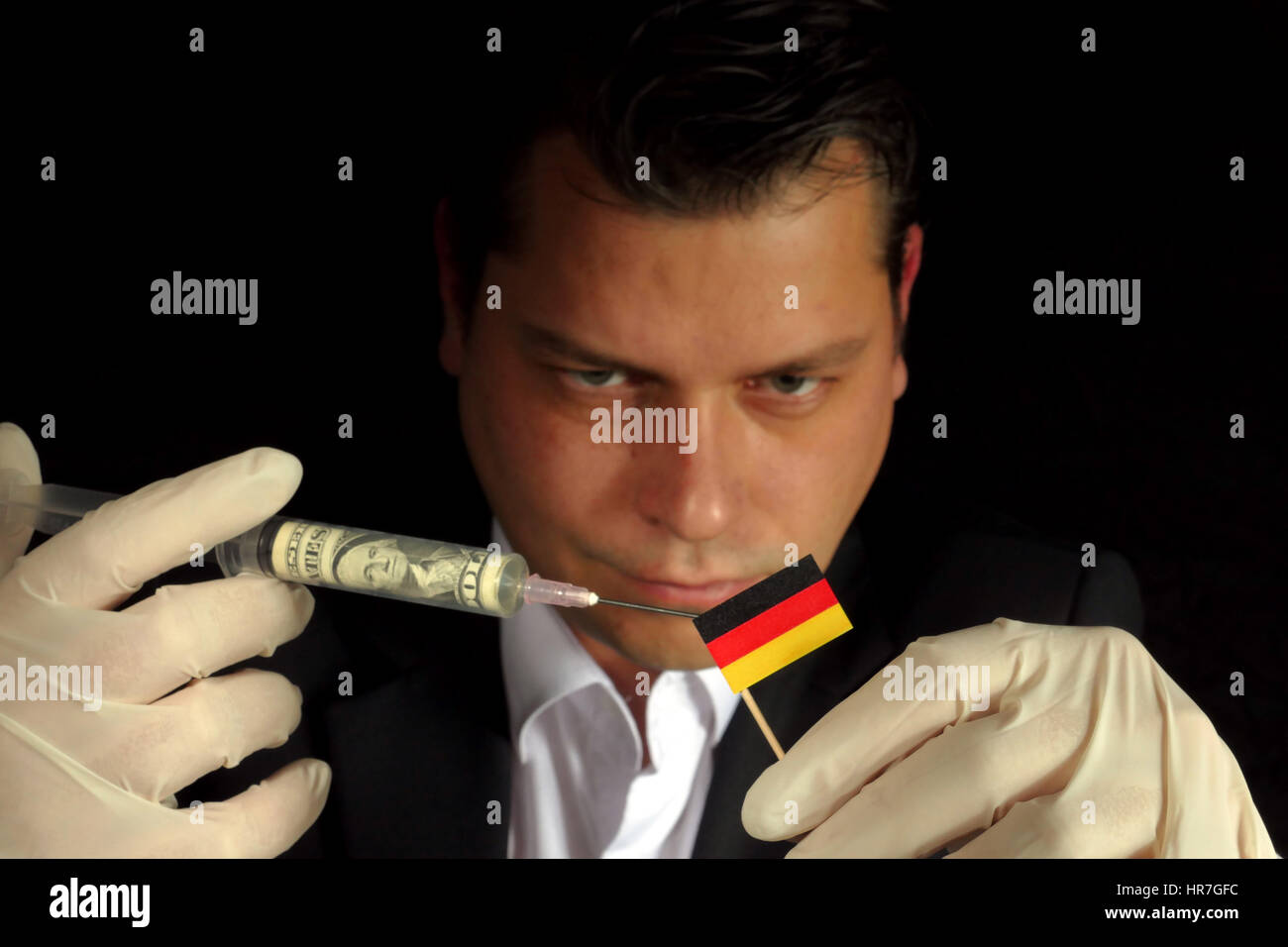 Young businessman gives a financial injection to German flag isolated ...