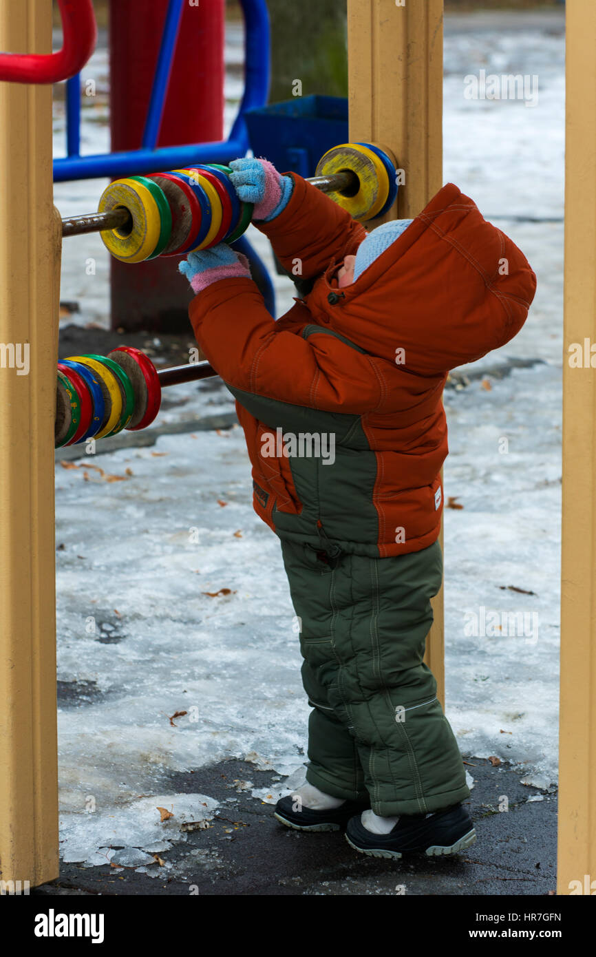 Children play on the playground in the winter on a holiday Maslenitsa ...