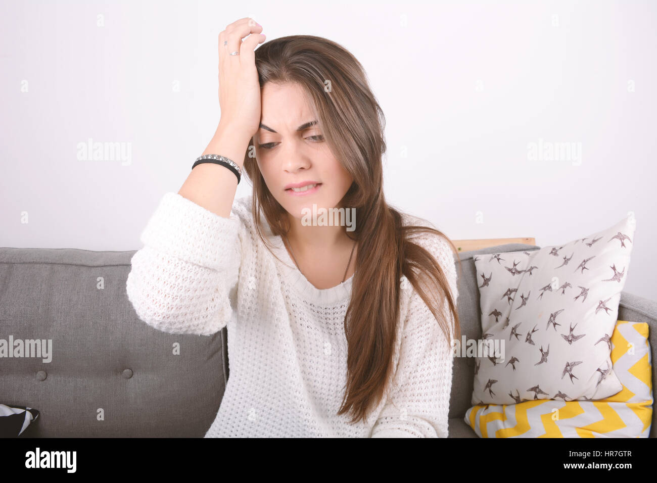 Beautiful young woman worried. Indoors Stock Photo - Alamy