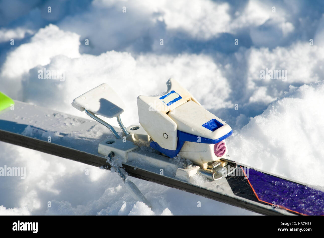 Ski closeup attachment mechanism lying on white snow Stock Photo - Alamy