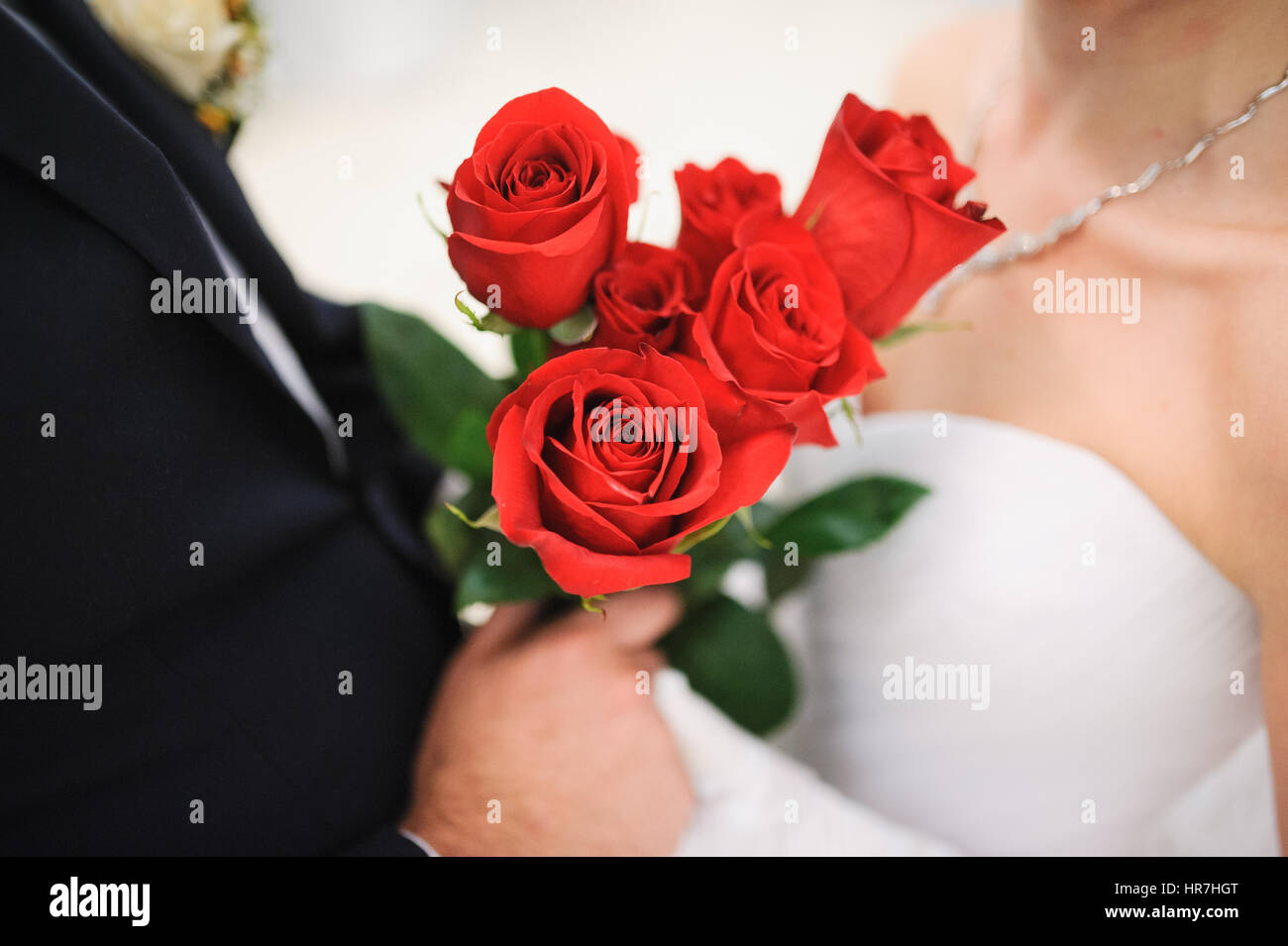 A bride and groom with flowers roses on wedding day Stock Photo - Alamy