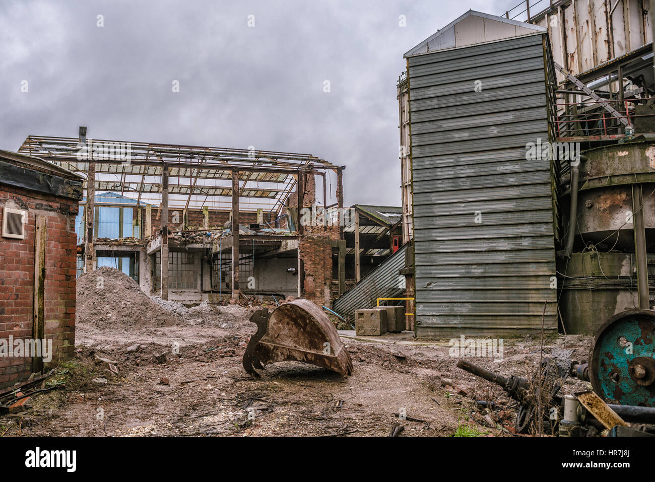 A demolition site of an old factory with rubble and steelwork with a ...