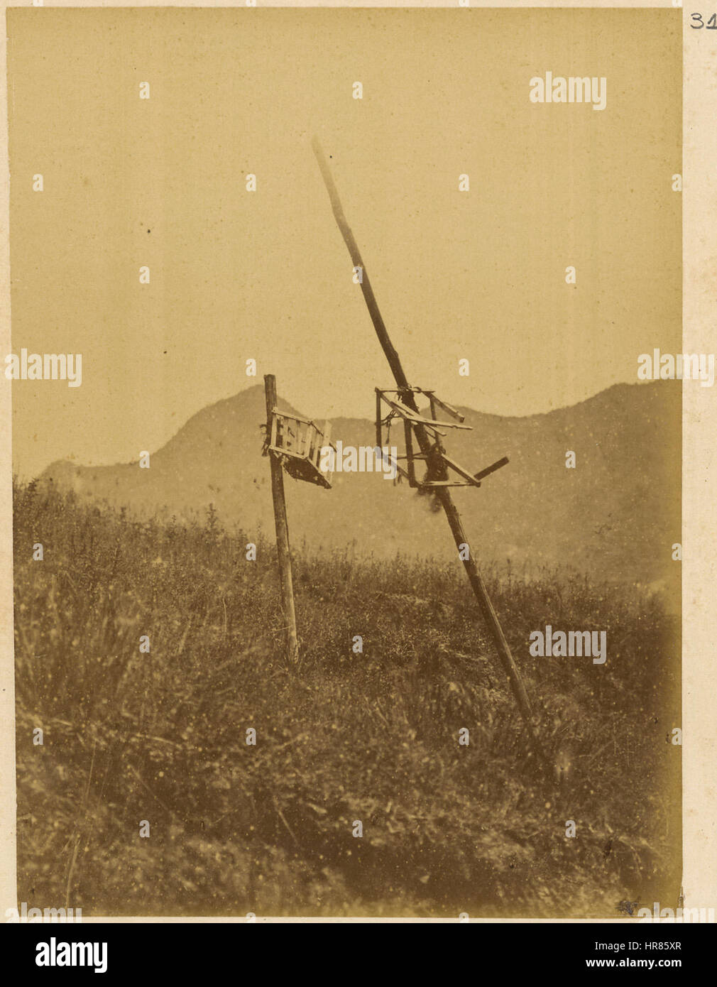 This historical image depicts wooden cages used to display the heads of ...