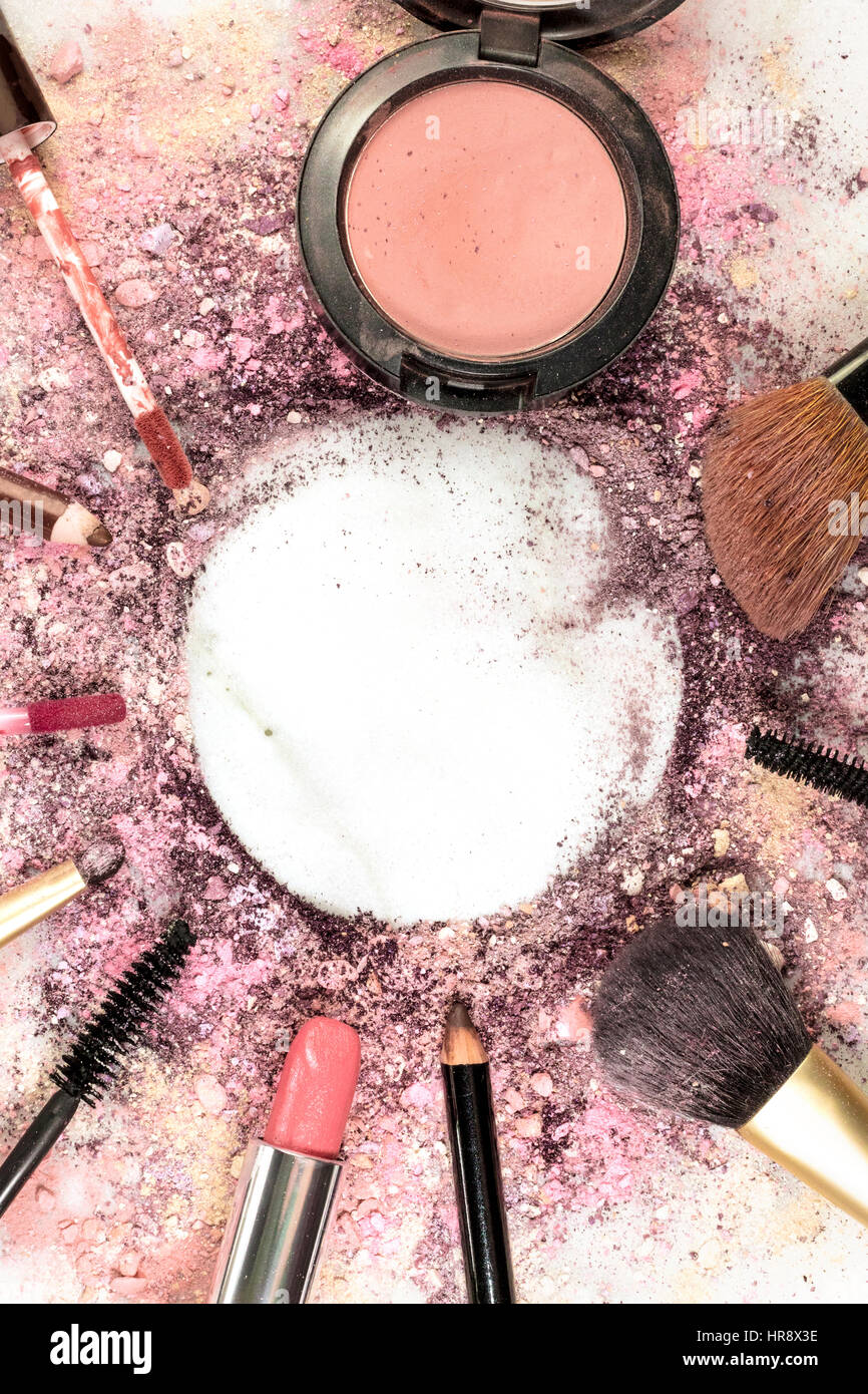 Makeup brushes, pencil, lipstick and other objects, forming a frame on ...