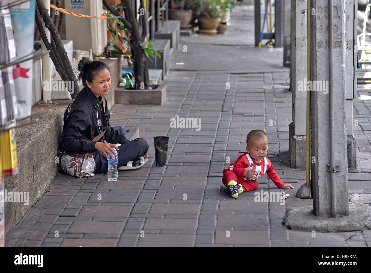 Beggar woman, baby. Young Thailand mother and her infant child begging ...
