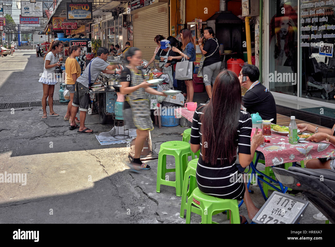 Thailand street food vendor and customers. Thailand people eating ...