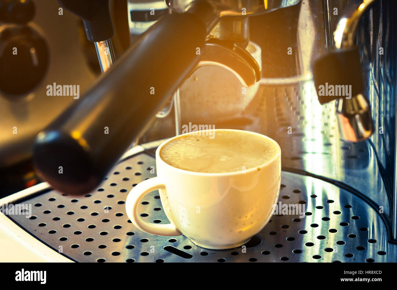 Professional coffee machine making espresso in a cafe with lighting ...