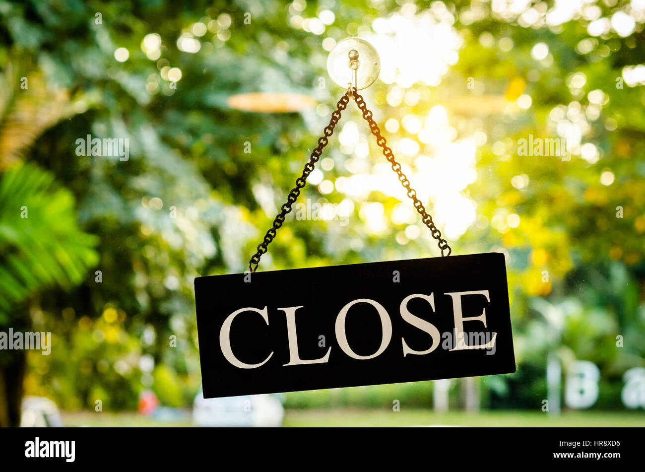 Closed sign board hanging in a shop window with retro effect filter ...