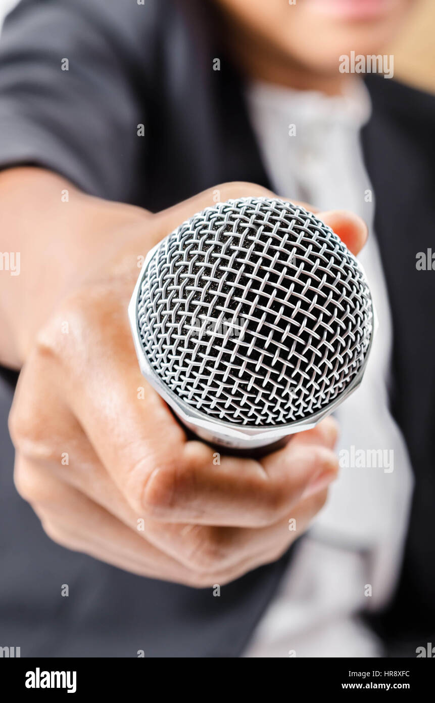 Hand holding a microphone conducting a business interview Stock Photo ...