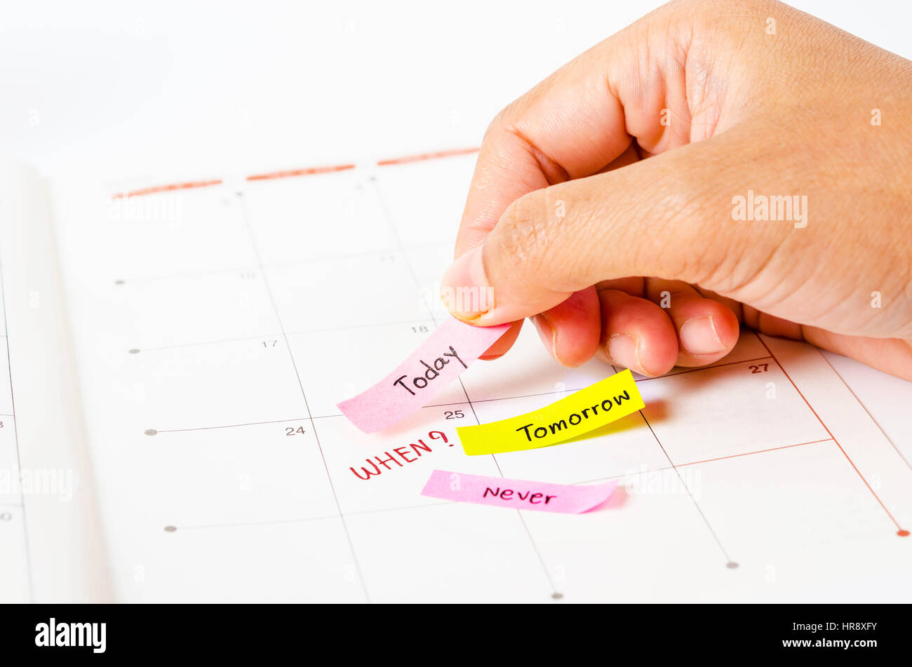 Hand Choosing the right date time management on calendar page Stock ...