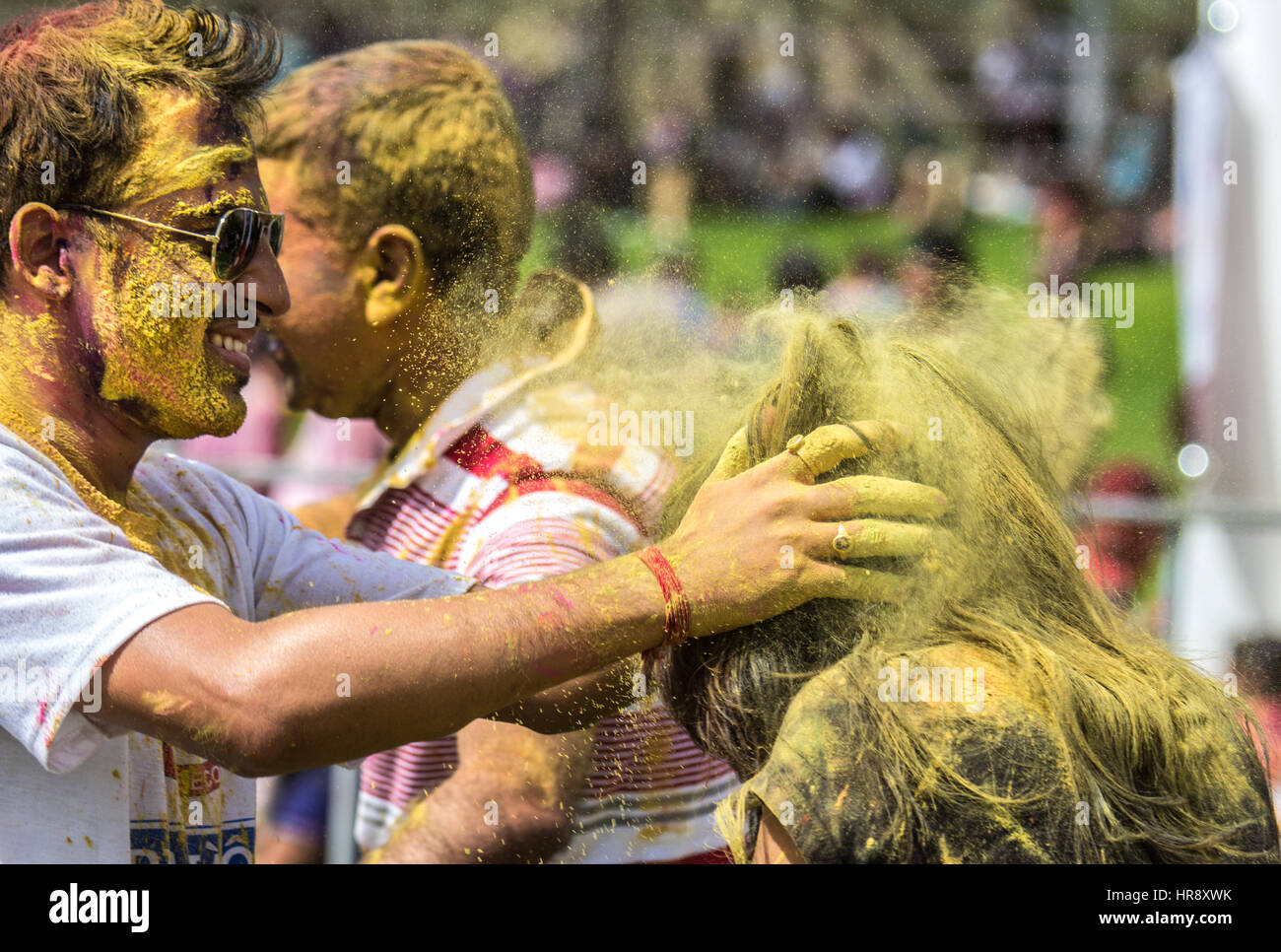 Dubai, UAE - Mar 21, 2014: People throwing colorful paint and powder ...