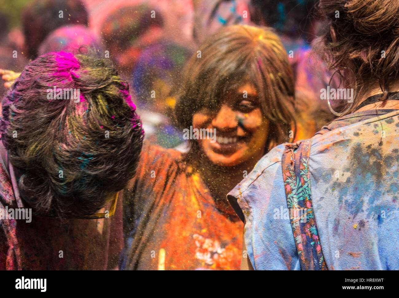 Dubai, UAE - Mar 21, 2014: People throwing colorful paint and powder ...
