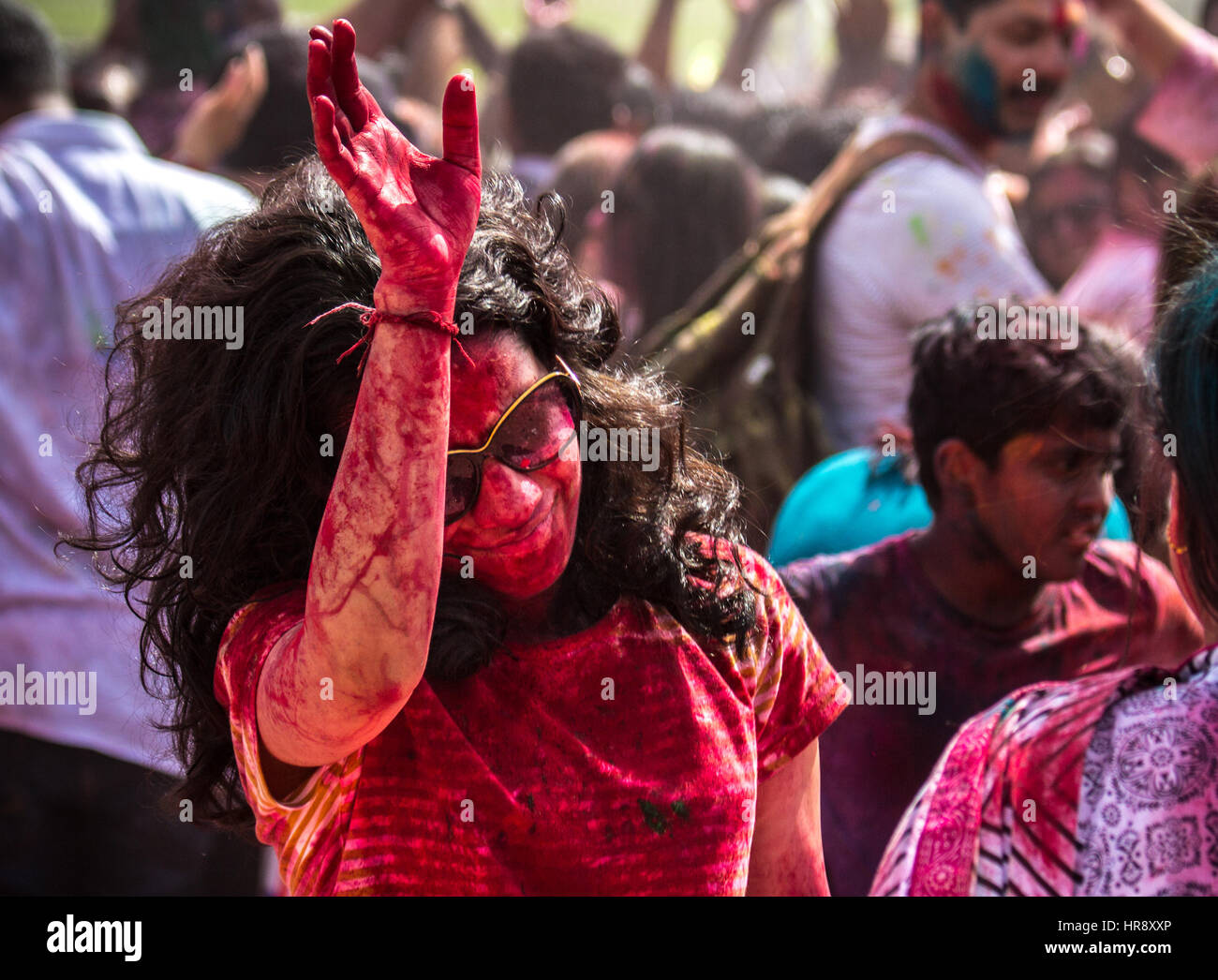 Dubai, UAE - Mar 21, 2014: People throwing colorful paint and powder ...