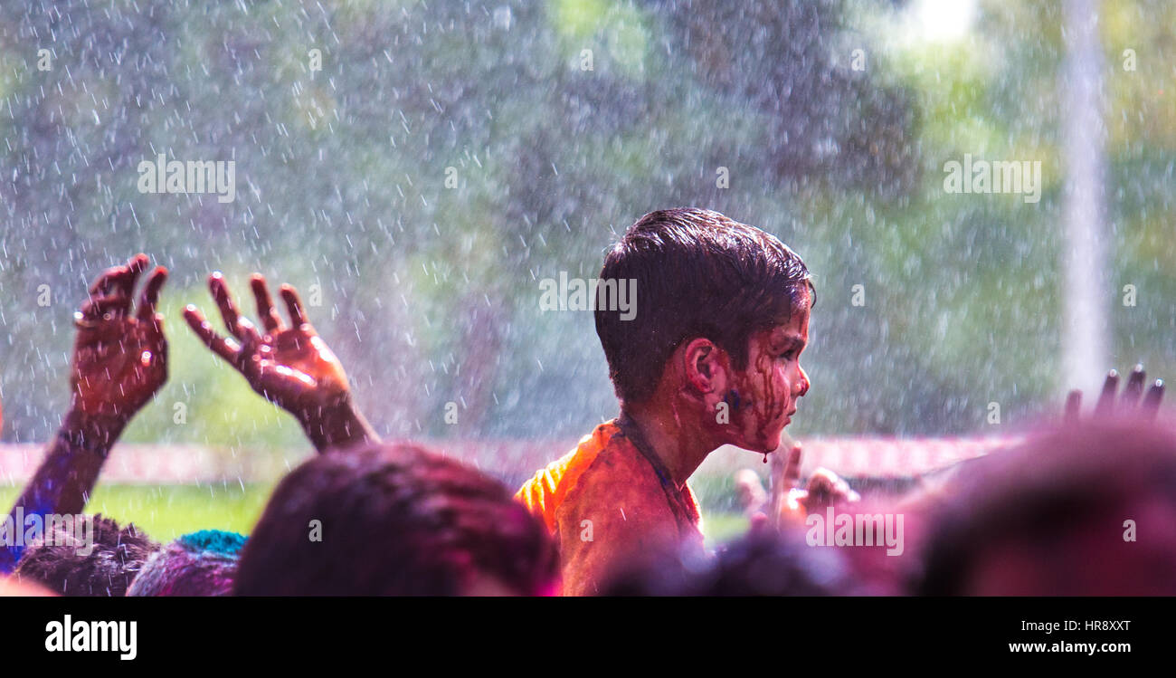 Dubai, UAE - Mar 21, 2014: People throwing colorful paint and powder ...