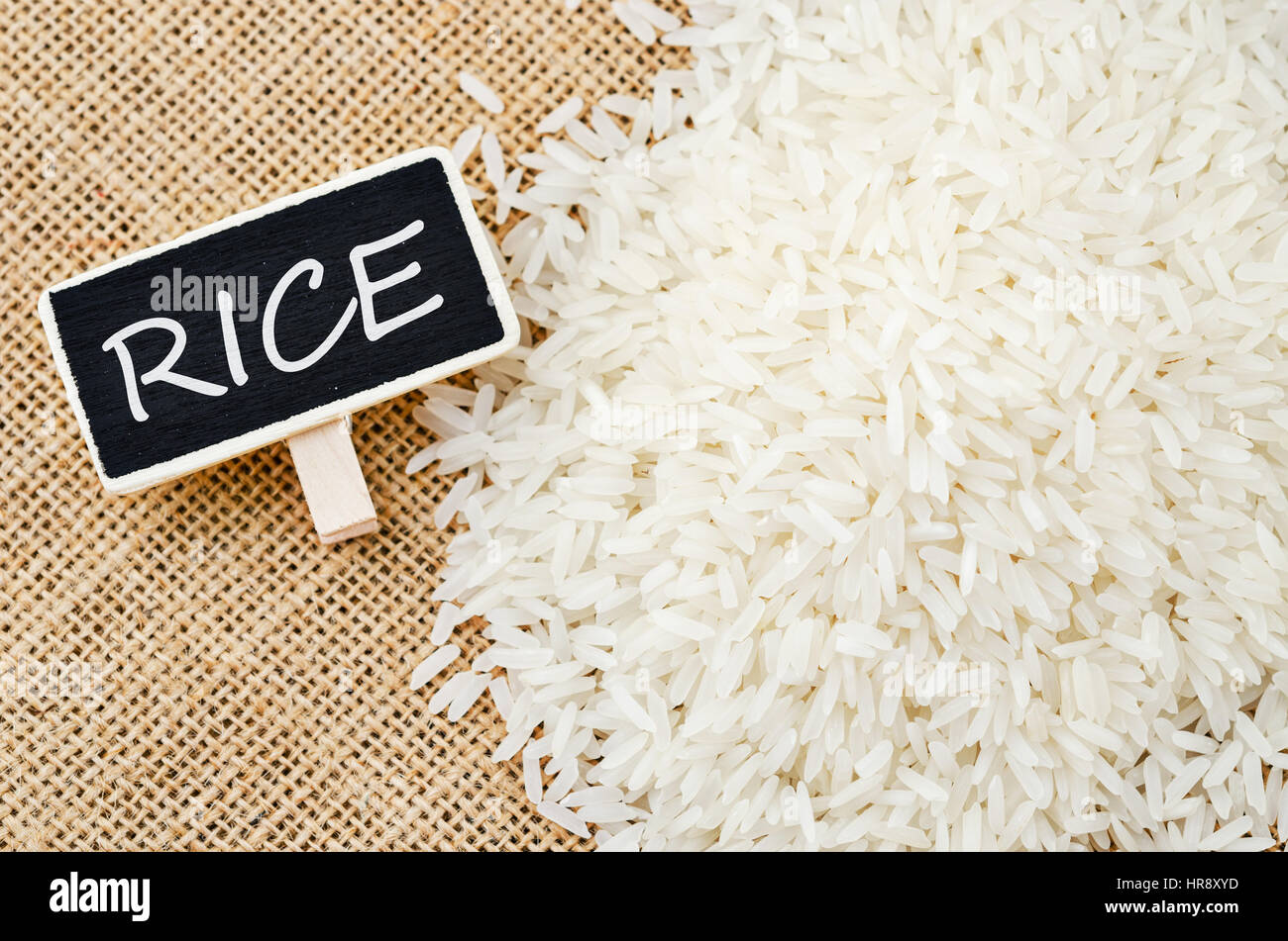 Raw white rice with RICE text on sack background Stock Photo - Alamy