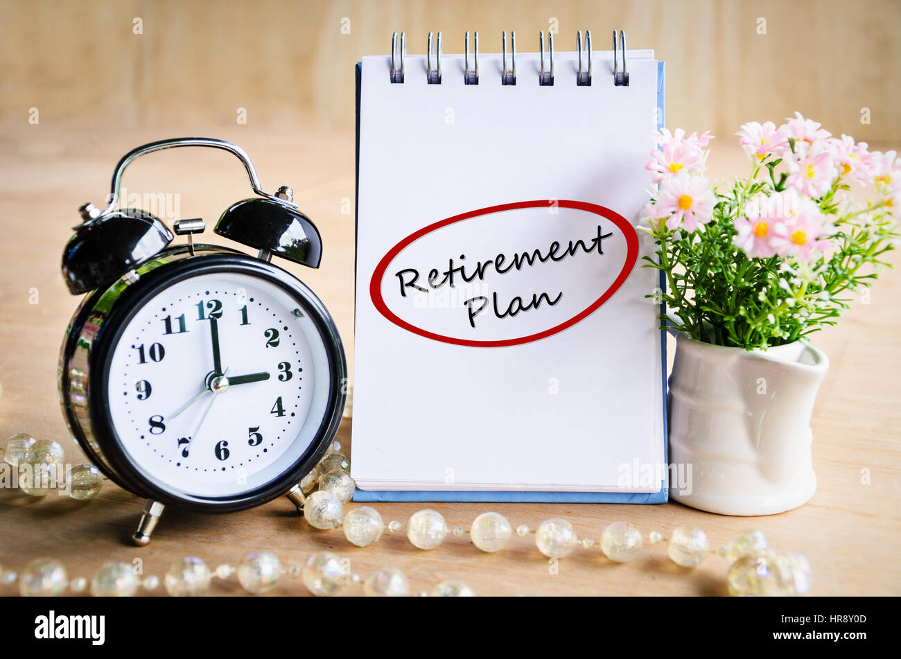 Retirement plan on open diary with alarm clock Stock Photo - Alamy