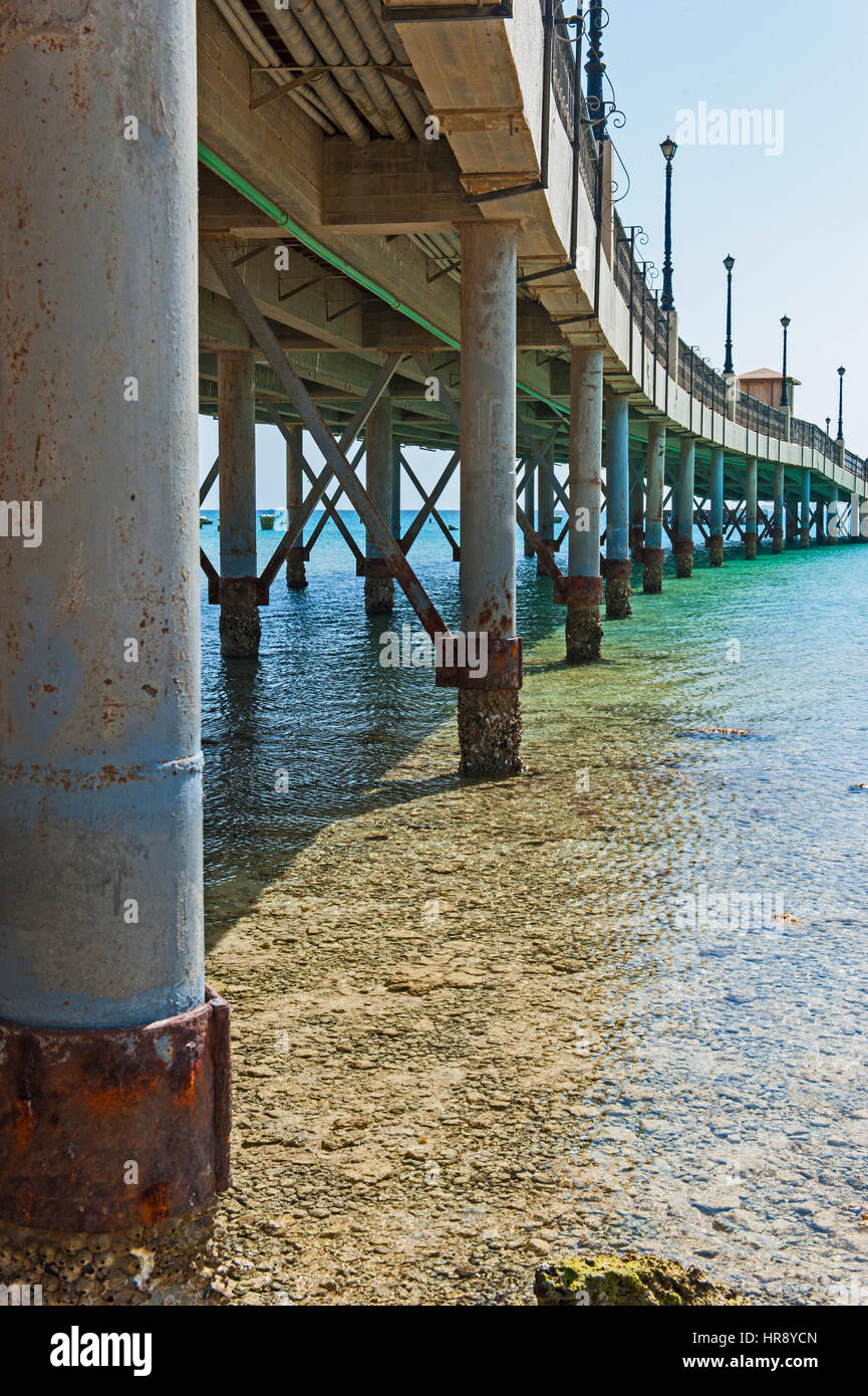 Metal supports of large pier in tropical sea on resort beach Stock ...