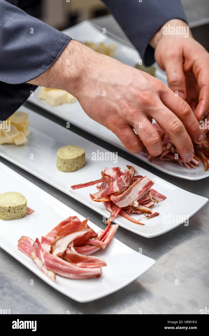 Chef preparing appetizer plates in restaurant kitchen Stock Photo - Alamy