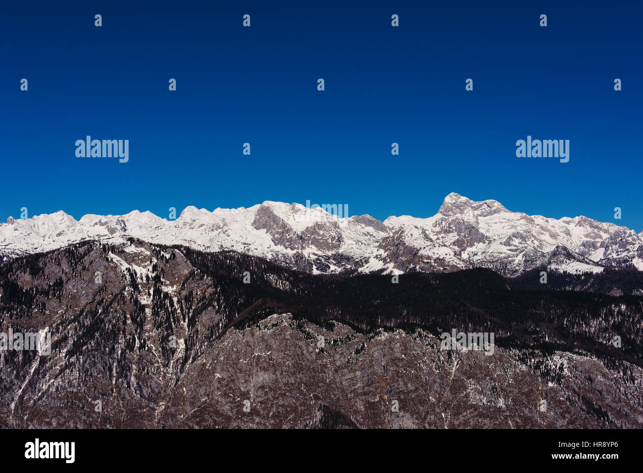 Triglav mountain peak covered in snow in Slovenia on bright winter day ...