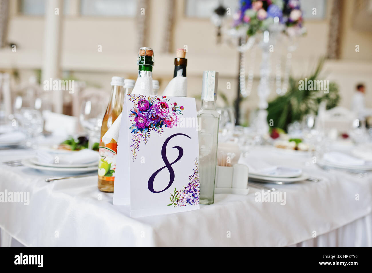 Number eight at table for guests on wedding hall Stock Photo - Alamy