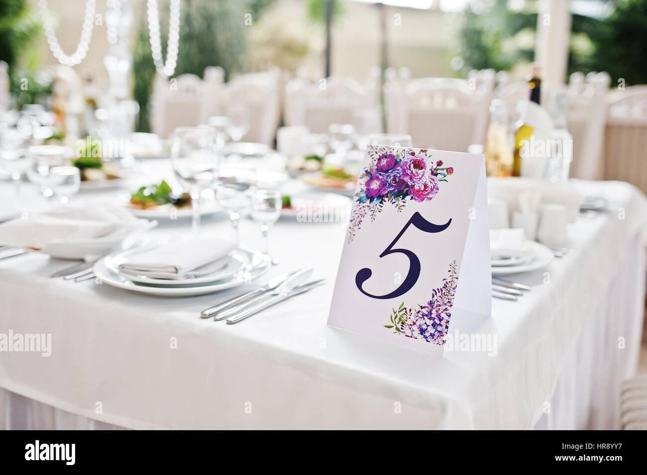 Number five at table for guests on wedding hall Stock Photo - Alamy