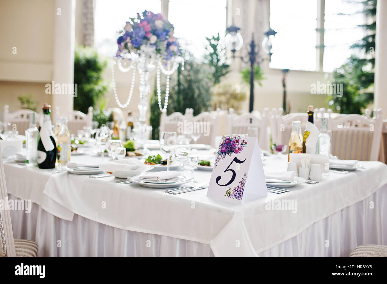 Number five at table for guests on wedding hall Stock Photo - Alamy