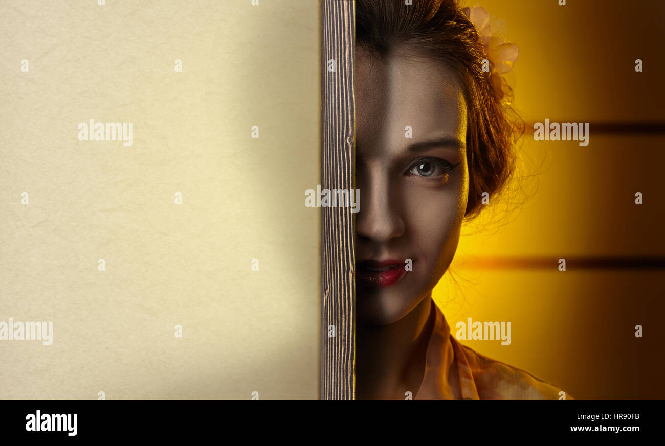 Happy young beautiful woman behind the paper screen, free space for ...