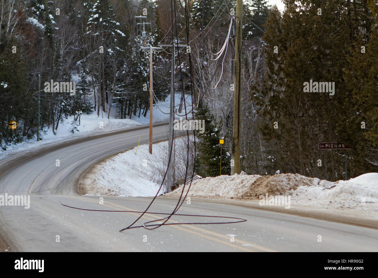 Broken utility wires laying on a road Stock Photo - Alamy