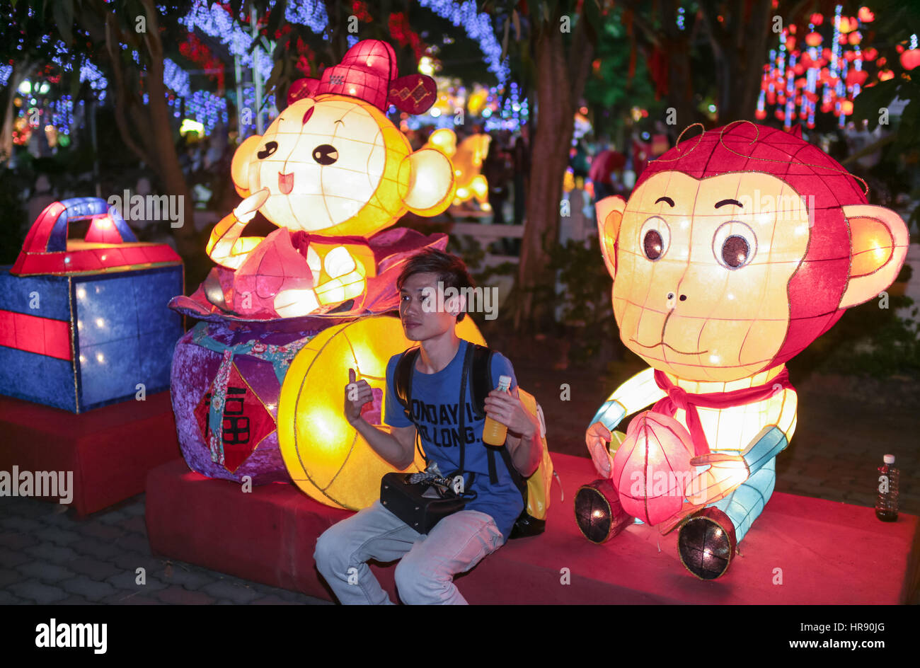 Teenager taking photo with LED light replica monkey at Fo Guang Shan ...
