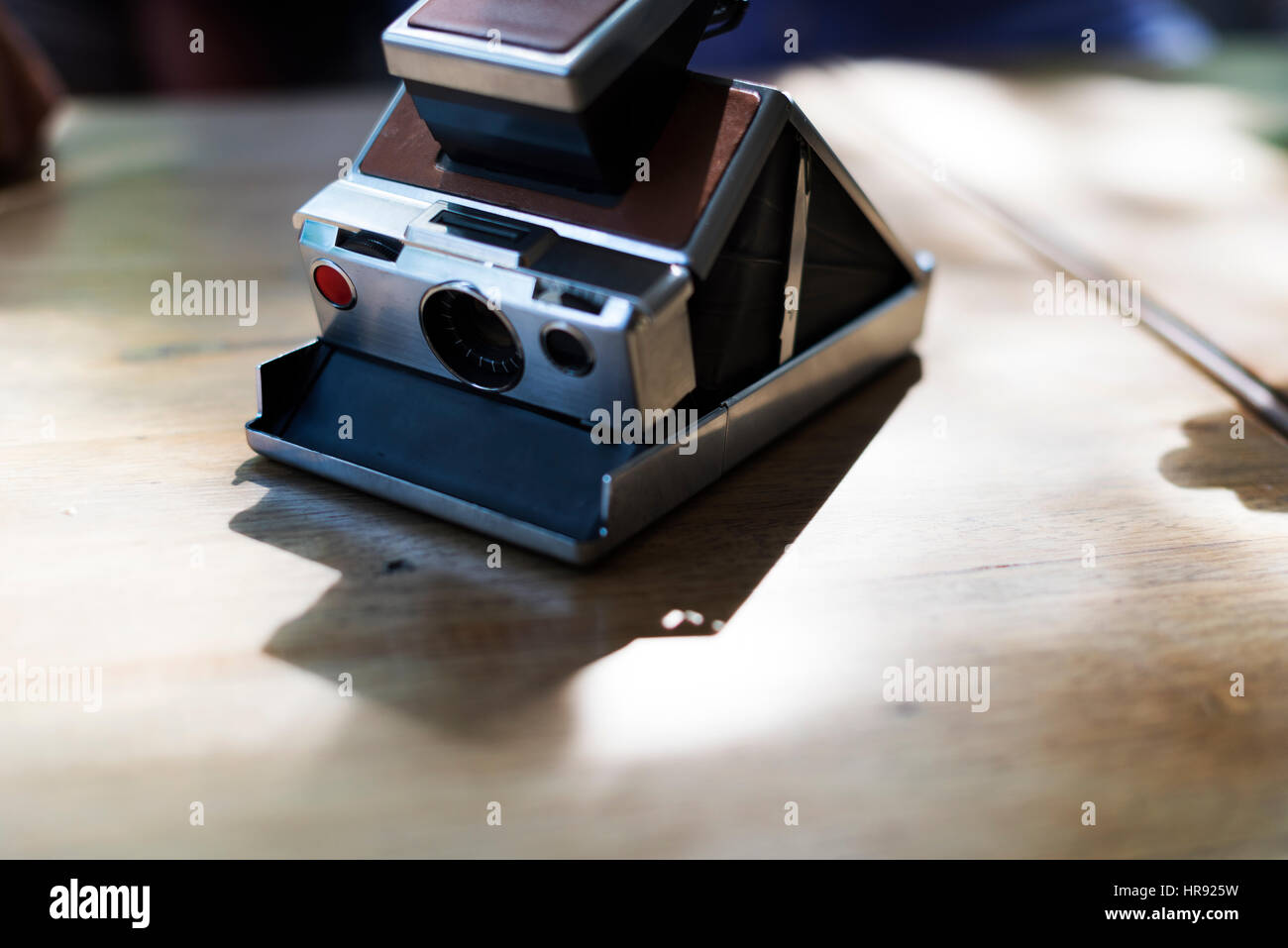 Vintage retro instant camera on table Stock Photo - Alamy