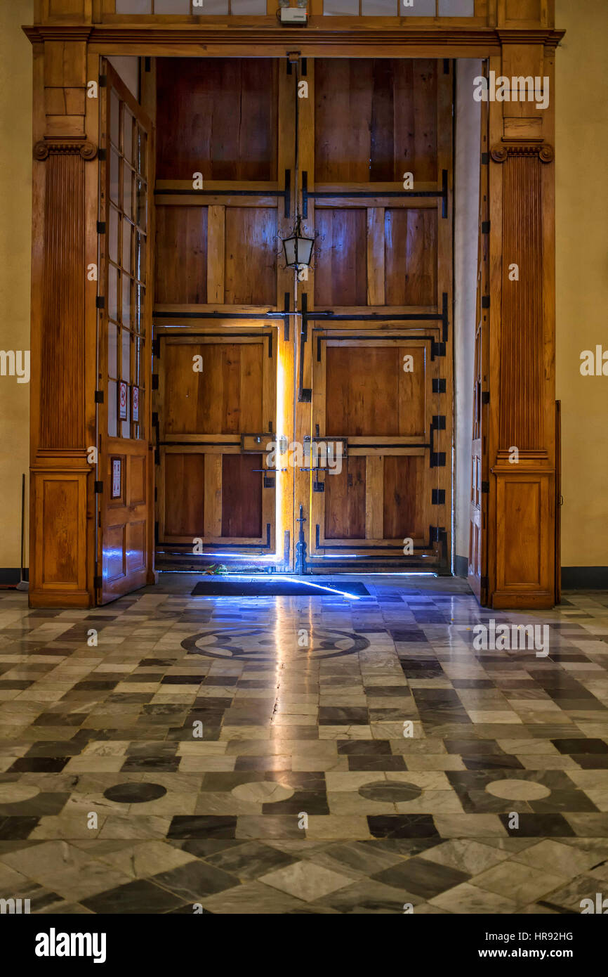 Inside a church with open oak door and sunlight shining in Stock Photo ...