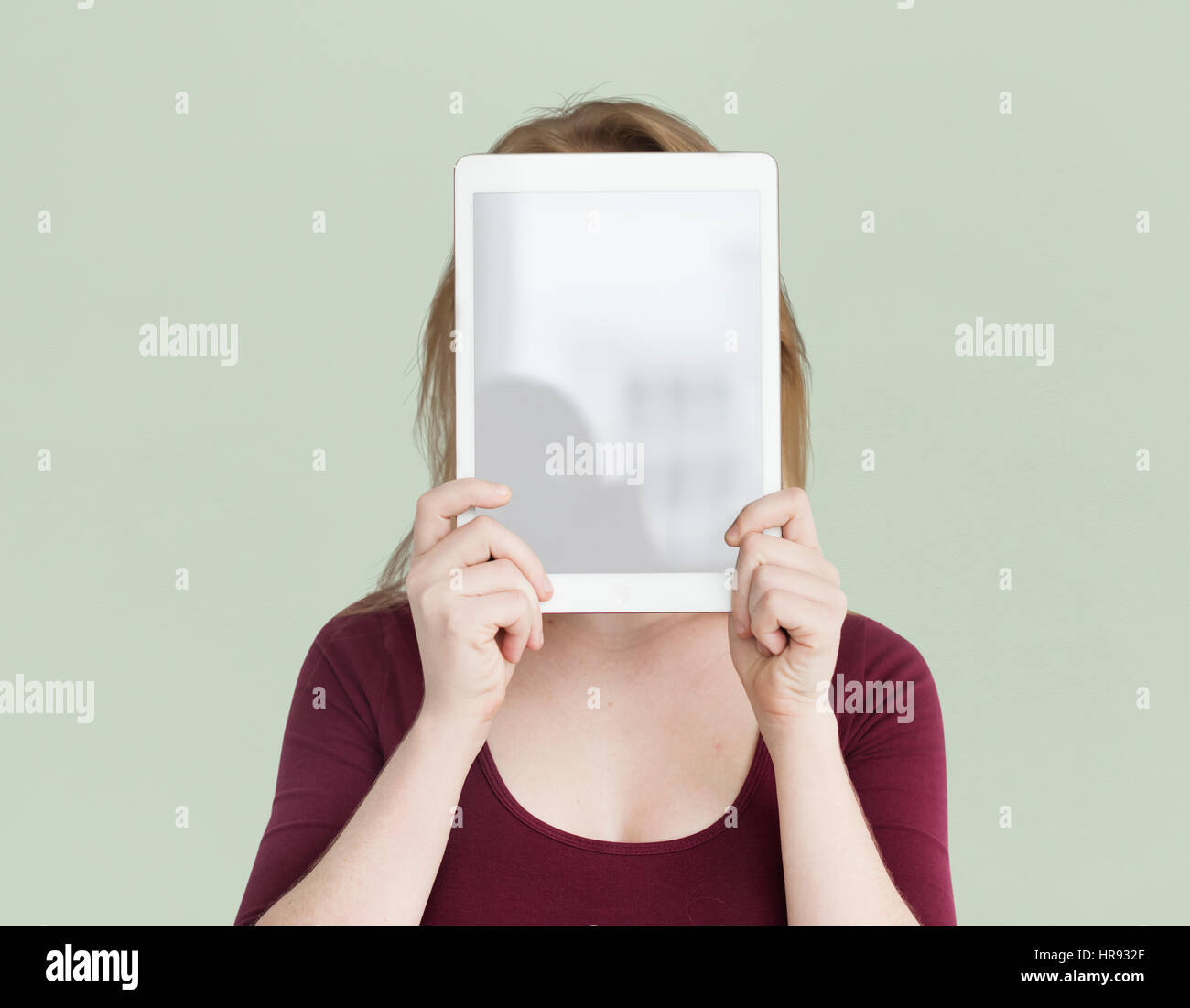 Woman Holding Up Tablet Covering Face Stock Photo - Alamy