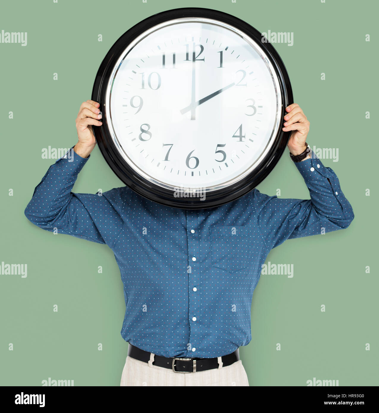 Man Holding Clock Covering Face Stock Photo - Alamy