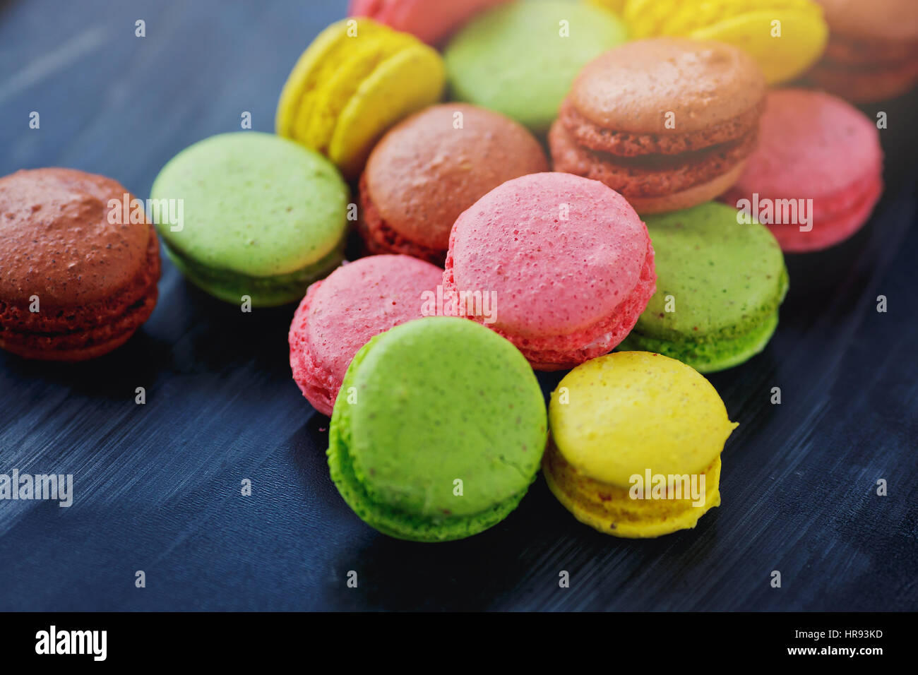 colorful macarons on black background Stock Photo - Alamy