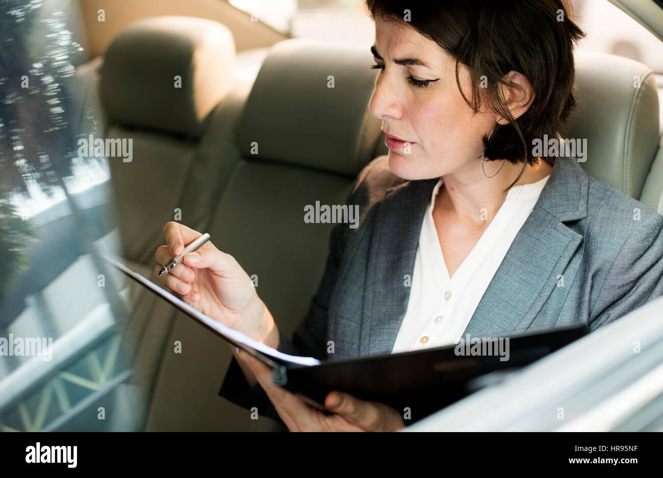 Businesswoman Busy Working Car Inside Stock Photo - Alamy