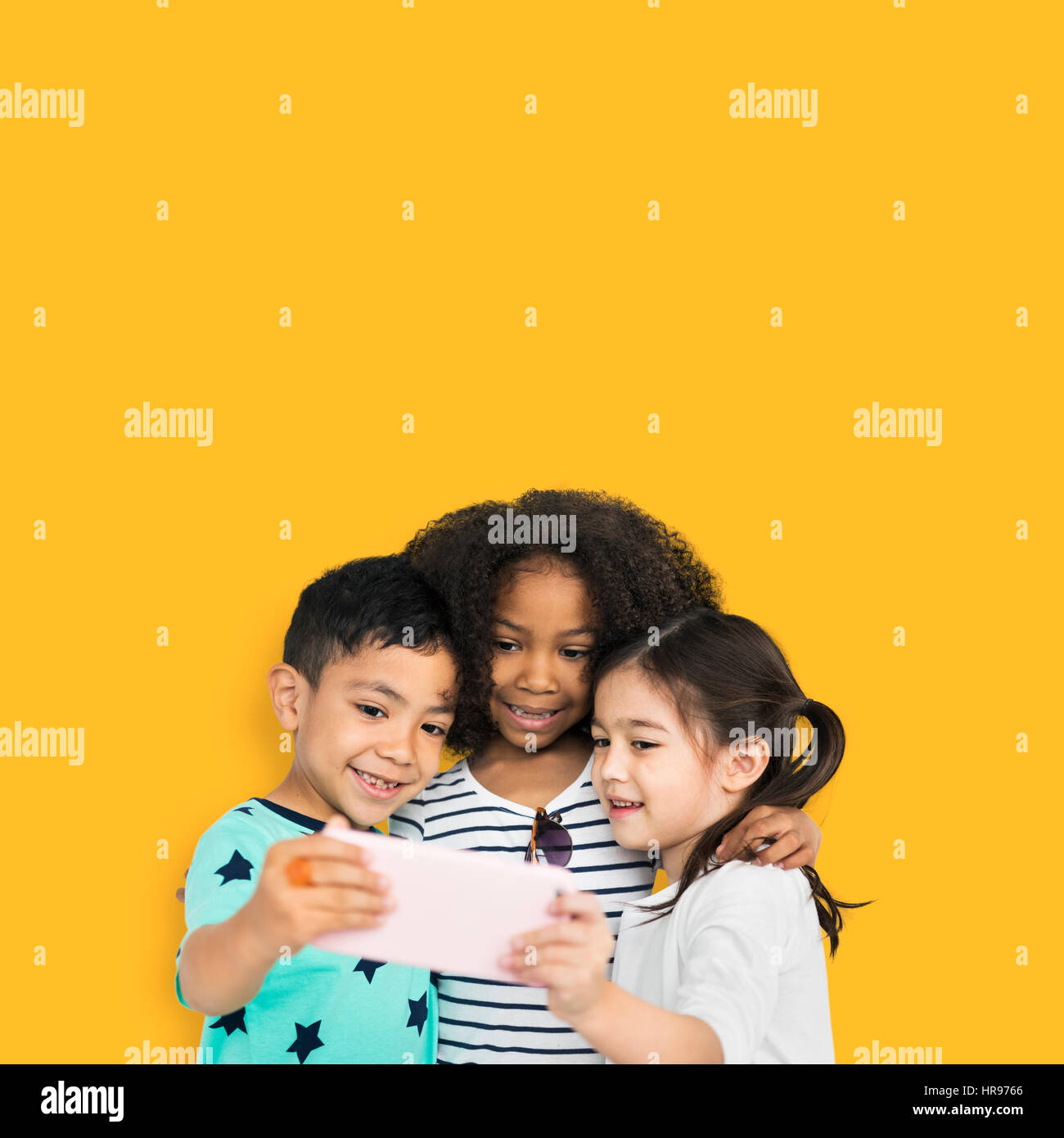 Little kids studio looking together with tablet Stock Photo - Alamy