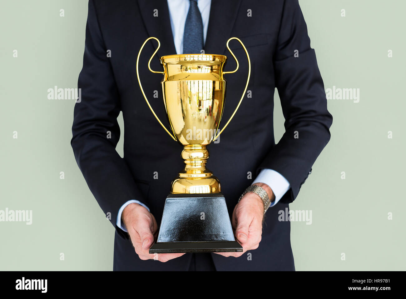Business Man Holding Trophy Award Stock Photo - Alamy