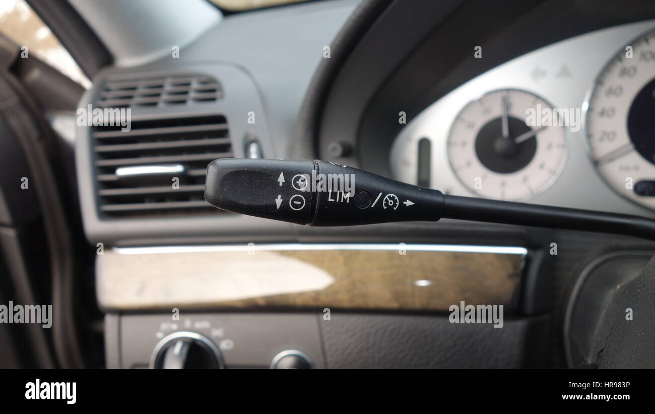 Close up automatic cruise control - tempomat command with blurred gages ...