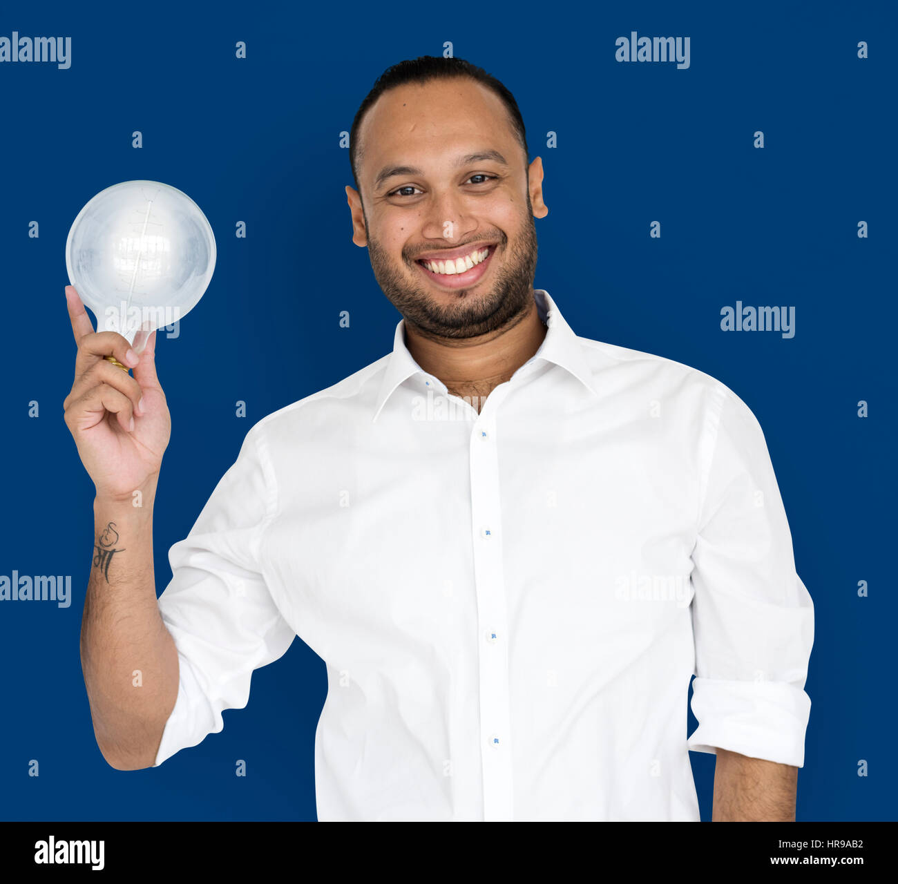 Indian Business Man Smiling Light Bulb Stock Photo - Alamy