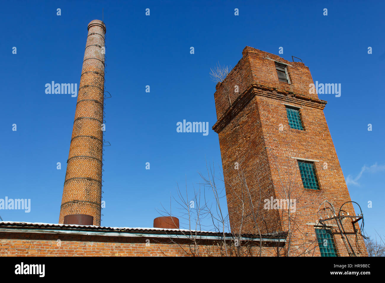 Old tower and pipe production on the background of blue sky Stock Photo ...