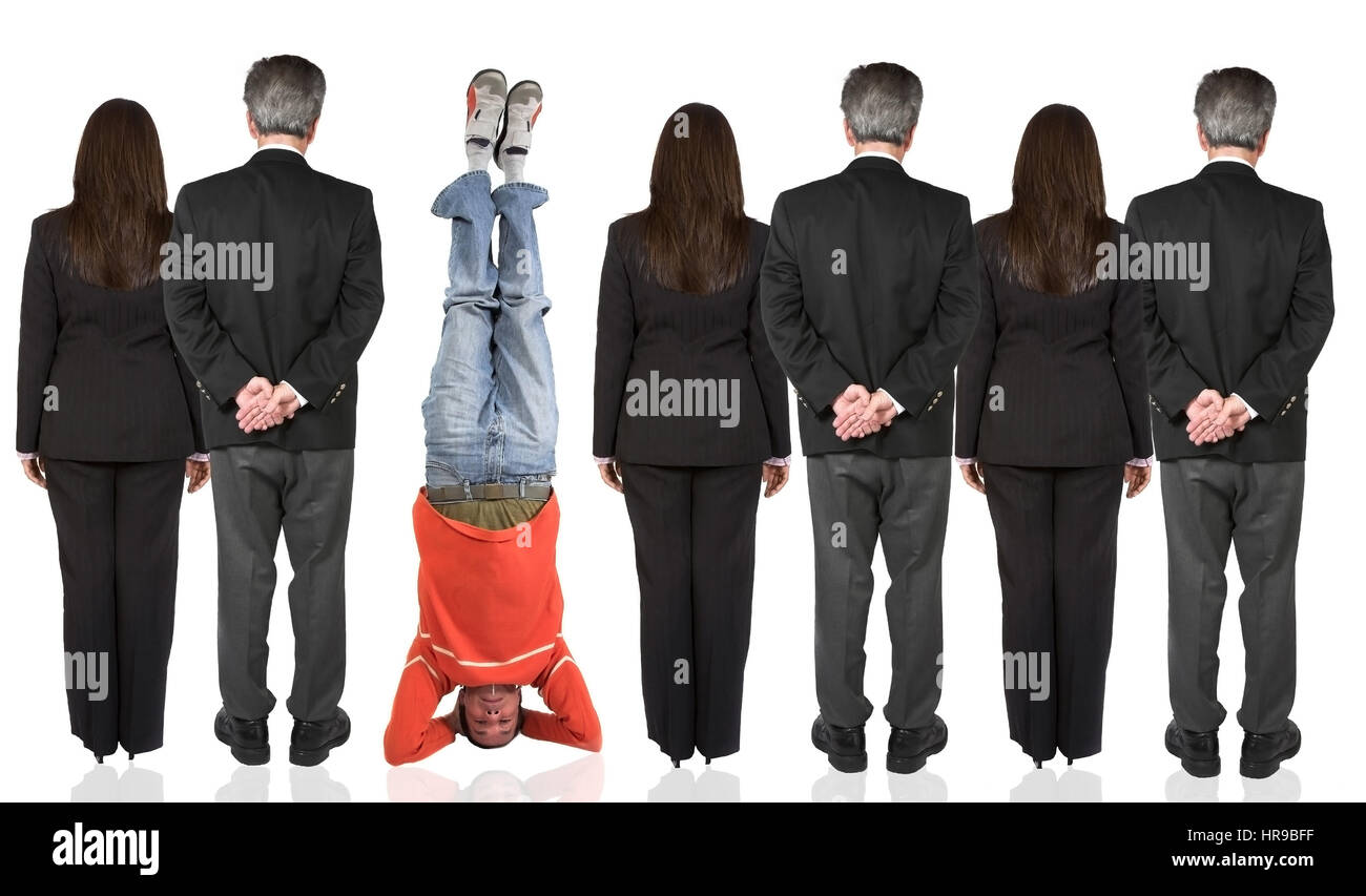 business people backwards with a casual guy doing the headstand Stock ...