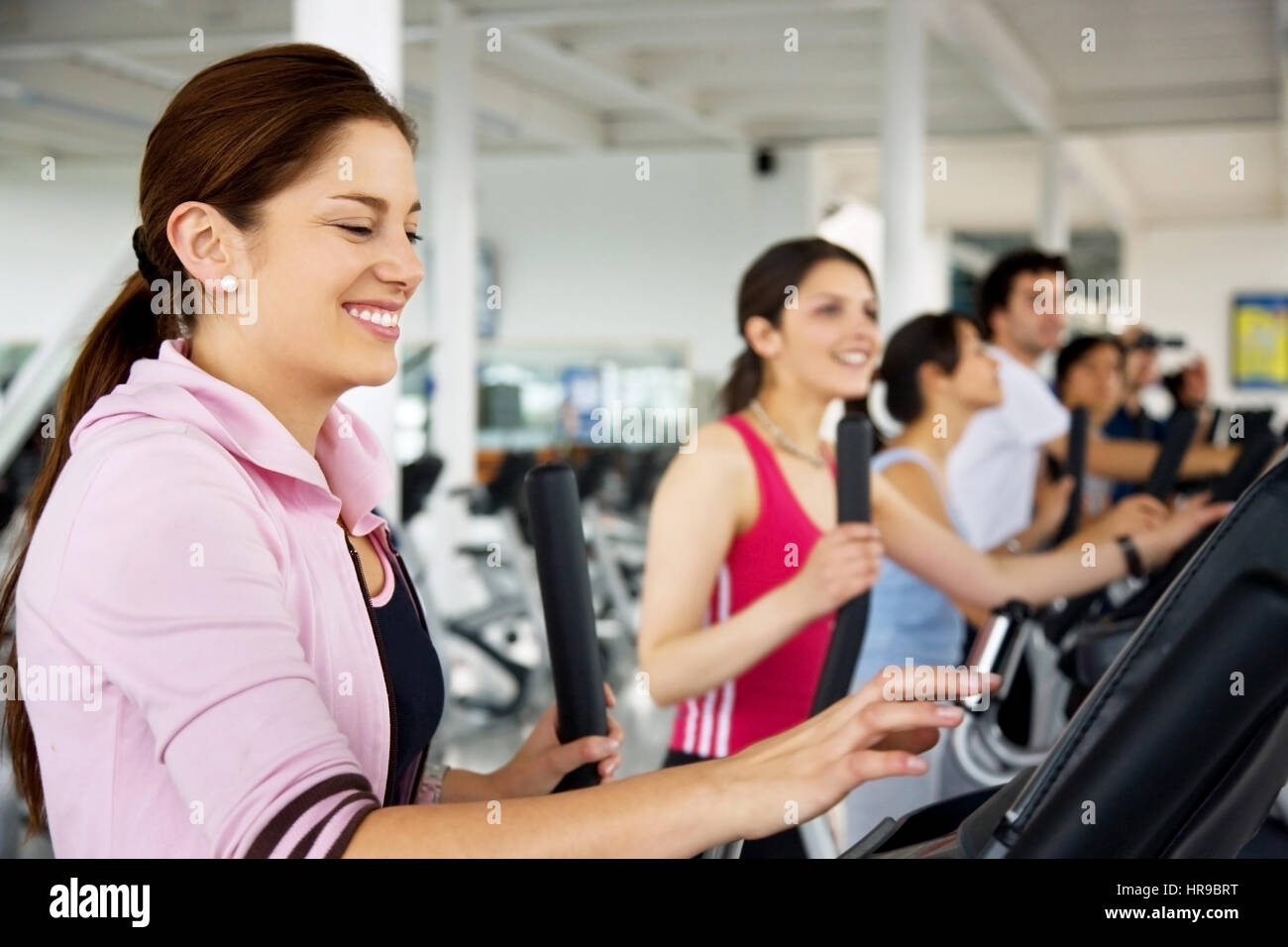 group of people at the gym doing exercise on the machines Stock Photo ...